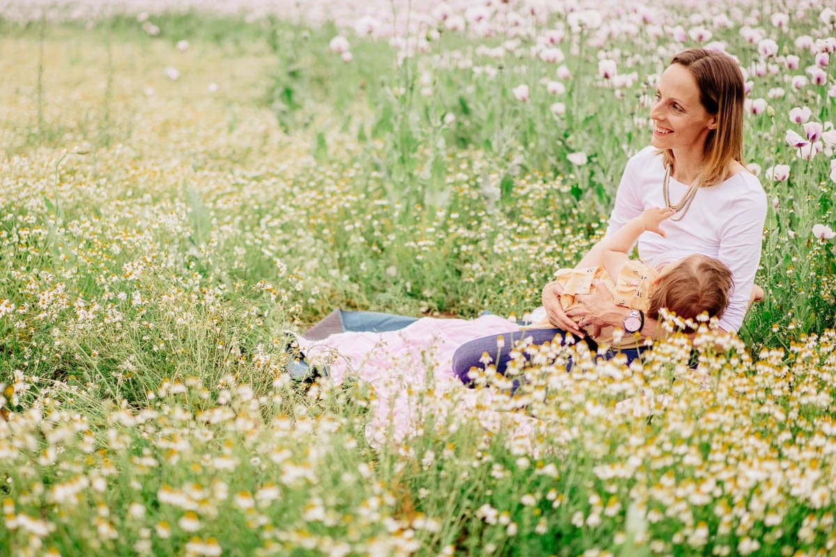 breastfeeding in summer meadow | Ideal Imaging by Alistair Jones